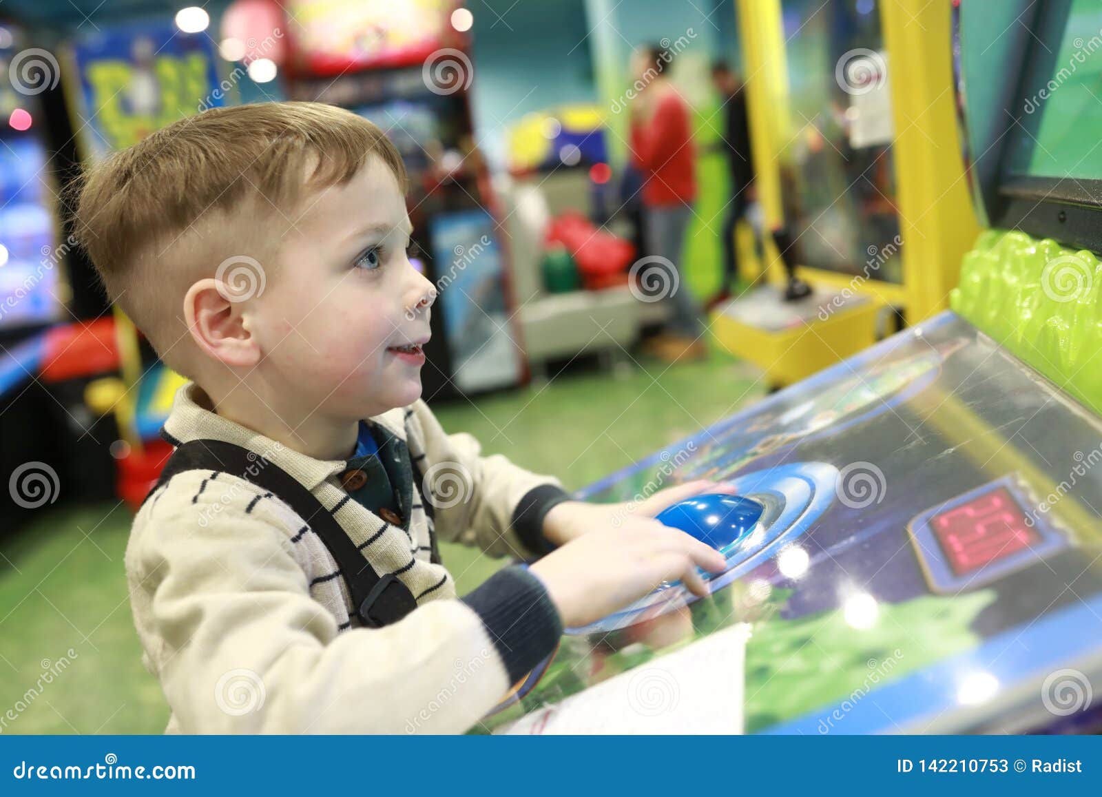 Boy plays arcade game stock image. Image of human, caucasian - 142210753
