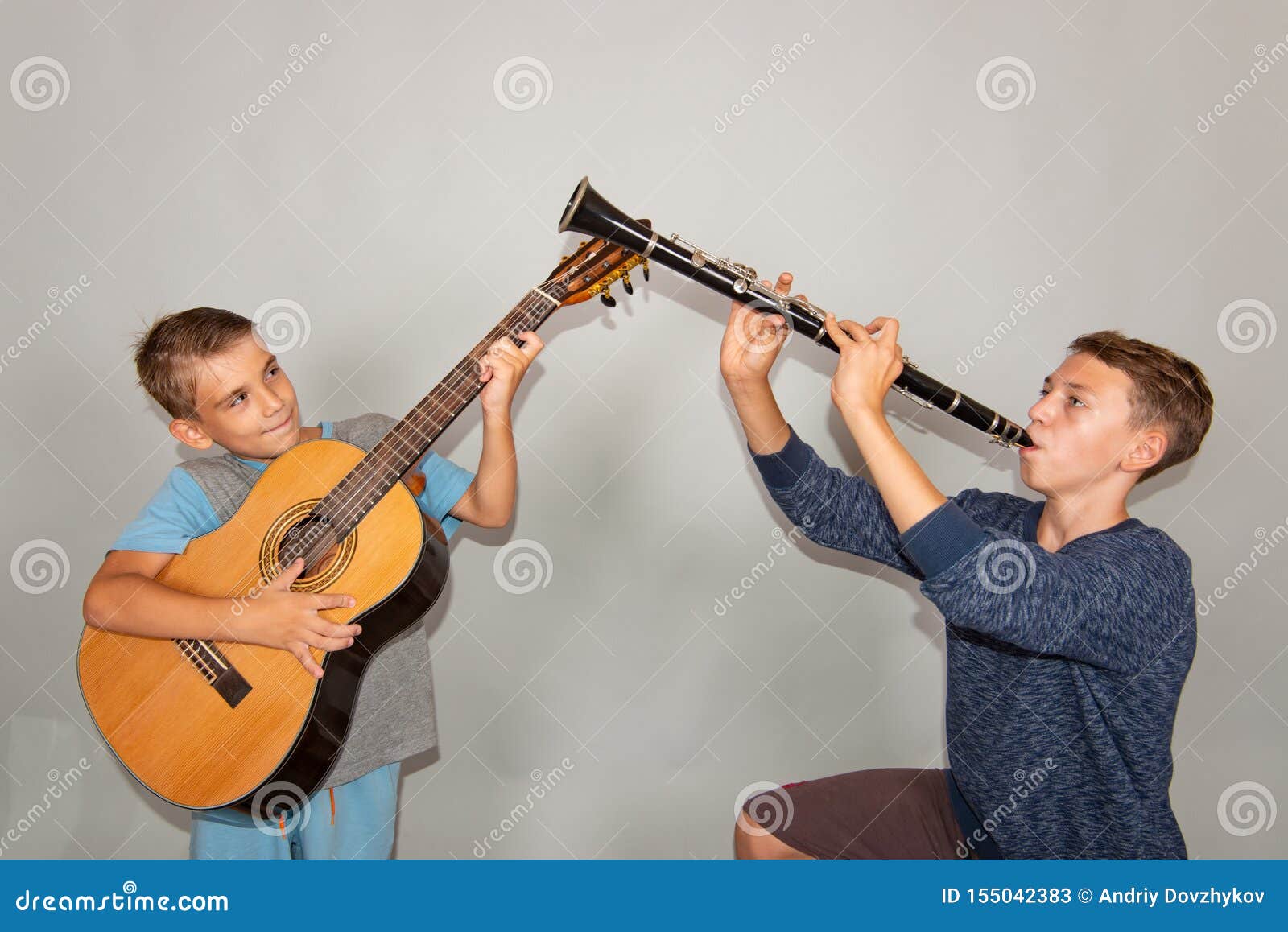 The Boy Plays the Guitar and Clarinet in Different Poses, Posing in the ...
