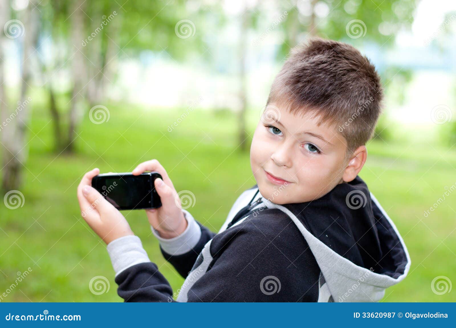 Boy Plays on a Mobile Phone in a Park Stock Image - Image of open, play ... Boy Plays on a Mobile Phone in a Park Stock Image - Image of open, play ...
