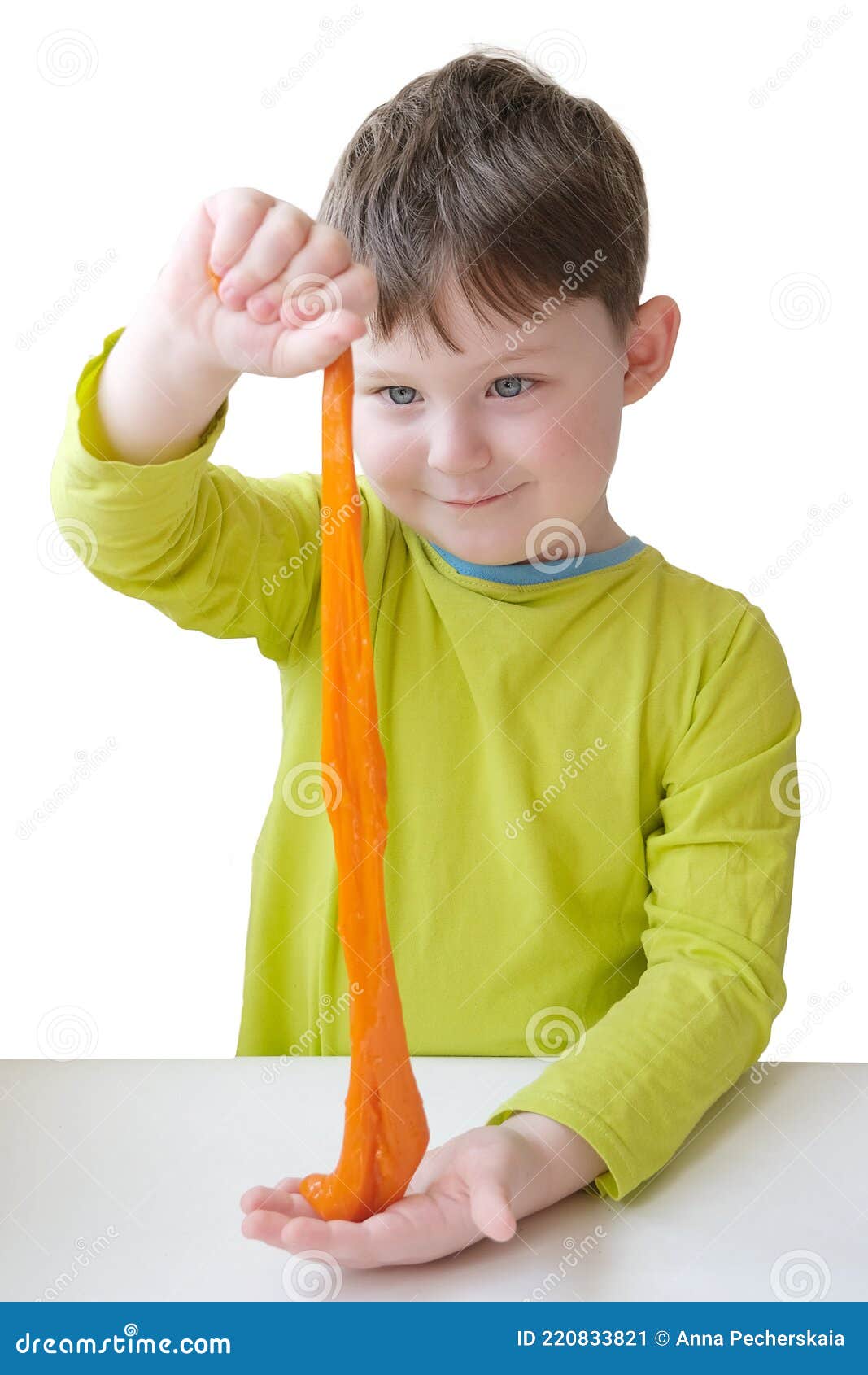 The Boy Plays with Orange Slime. Looks, Smiles As it Flows Stock Image ...
