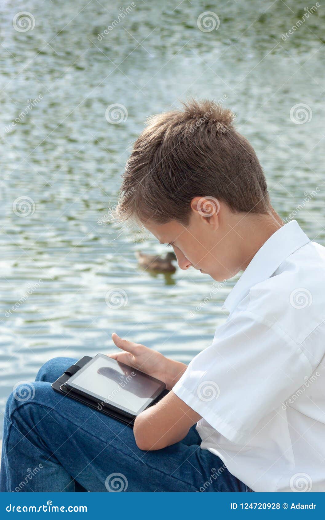 The Boy Plays in Phone in the Park Stock Photo - Image of application ... The Boy Plays in Phone in the Park Stock Photo - Image of application ...