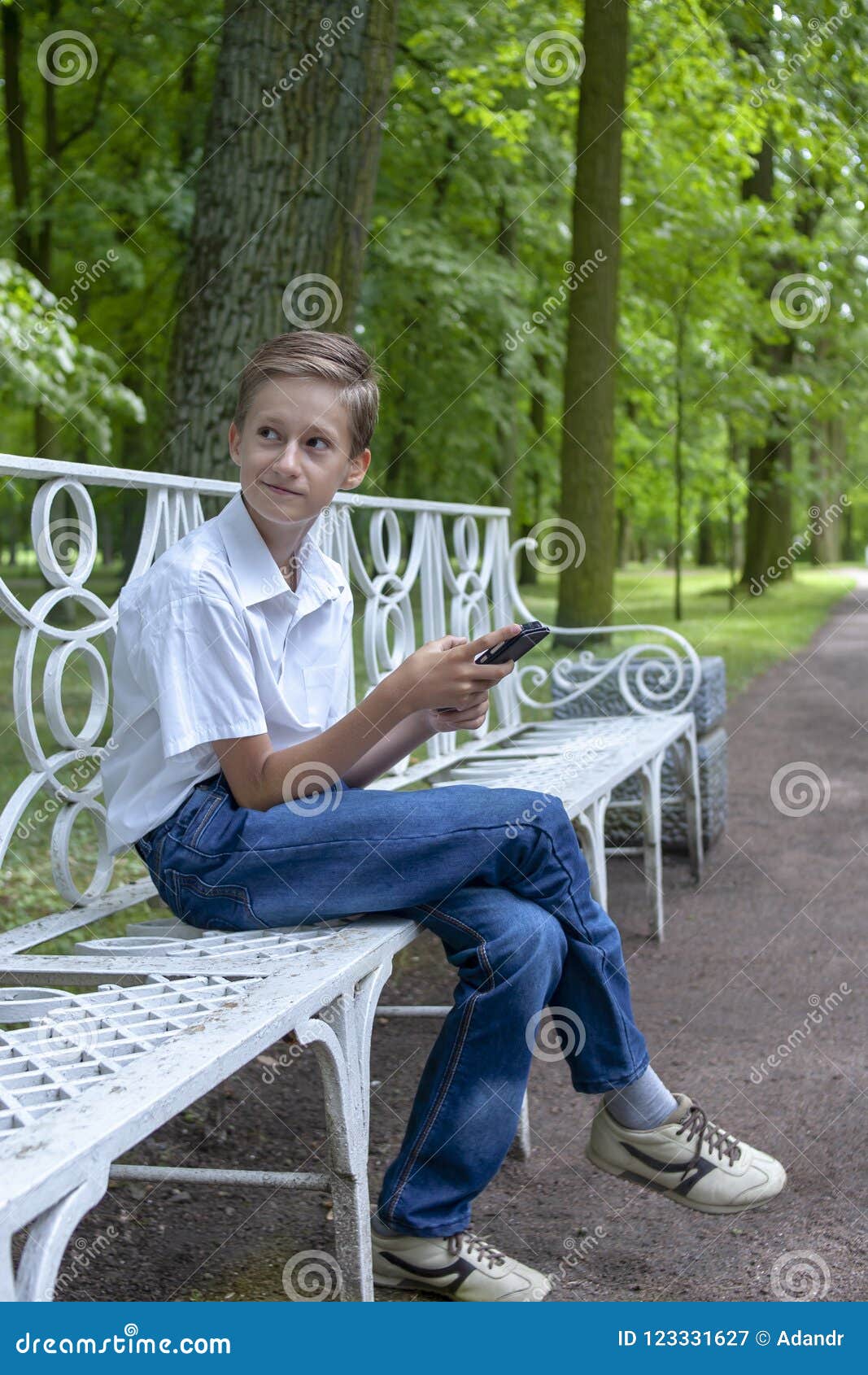 The Boy Plays in Phone in the Park Stock Image - Image of internet ... The Boy Plays in Phone in the Park Stock Image - Image of internet ...