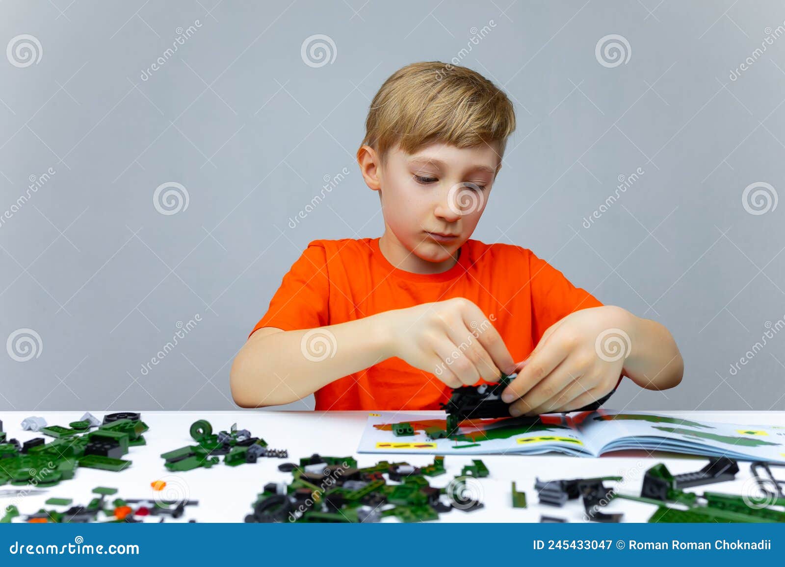 The Boy Plays with the Plastic Constructor Connects the Details Stock ...