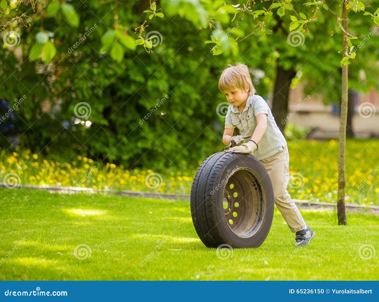 A Boy Plays with the Wheel of the Car Stock Photo - Image of park ...