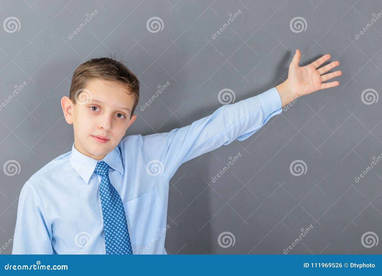 A Boy Pointing a Gesture at Something on the School Board Stock Photo ...