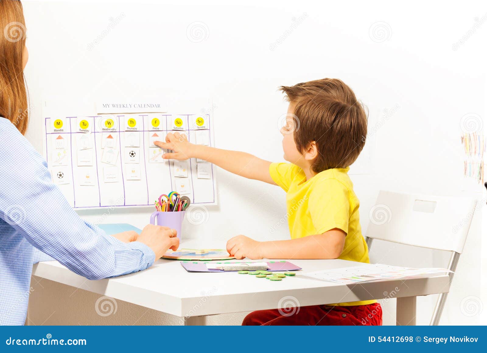 Boy Points at Activities on Calendar Learning Days Stock Photo - Image ...