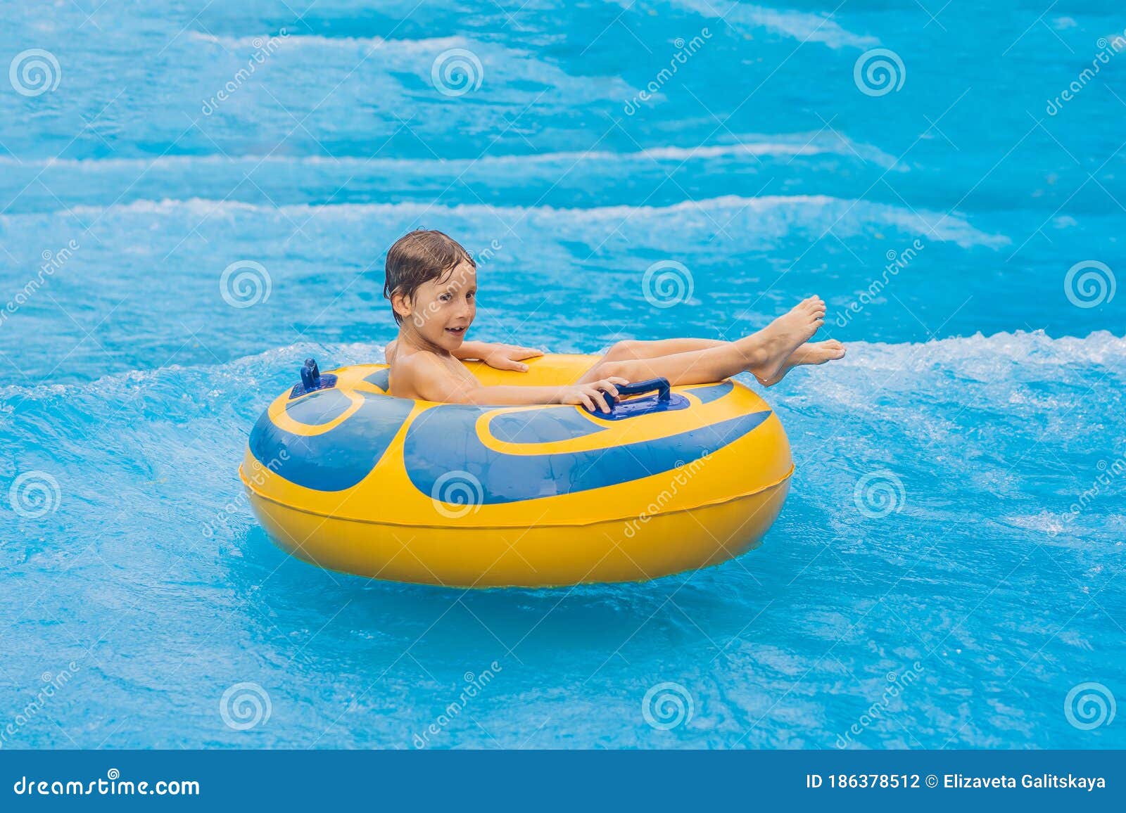 Boy on a Pool Float on Artificial Waves in a Water Park Stock Photo ...