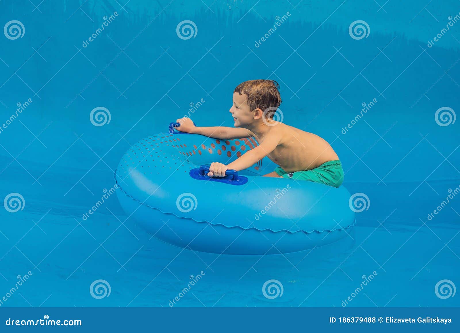 Boy on a Pool Float on Artificial Waves in a Water Park Stock Photo ...
