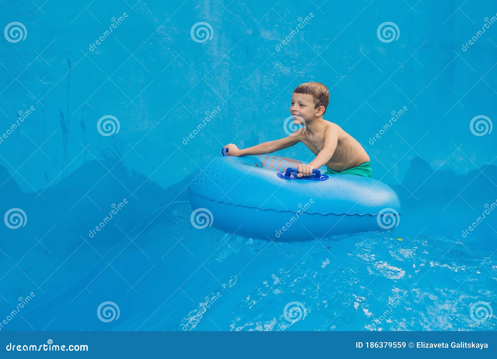 Boy on a Pool Float on Artificial Waves in a Water Park Stock Image ...