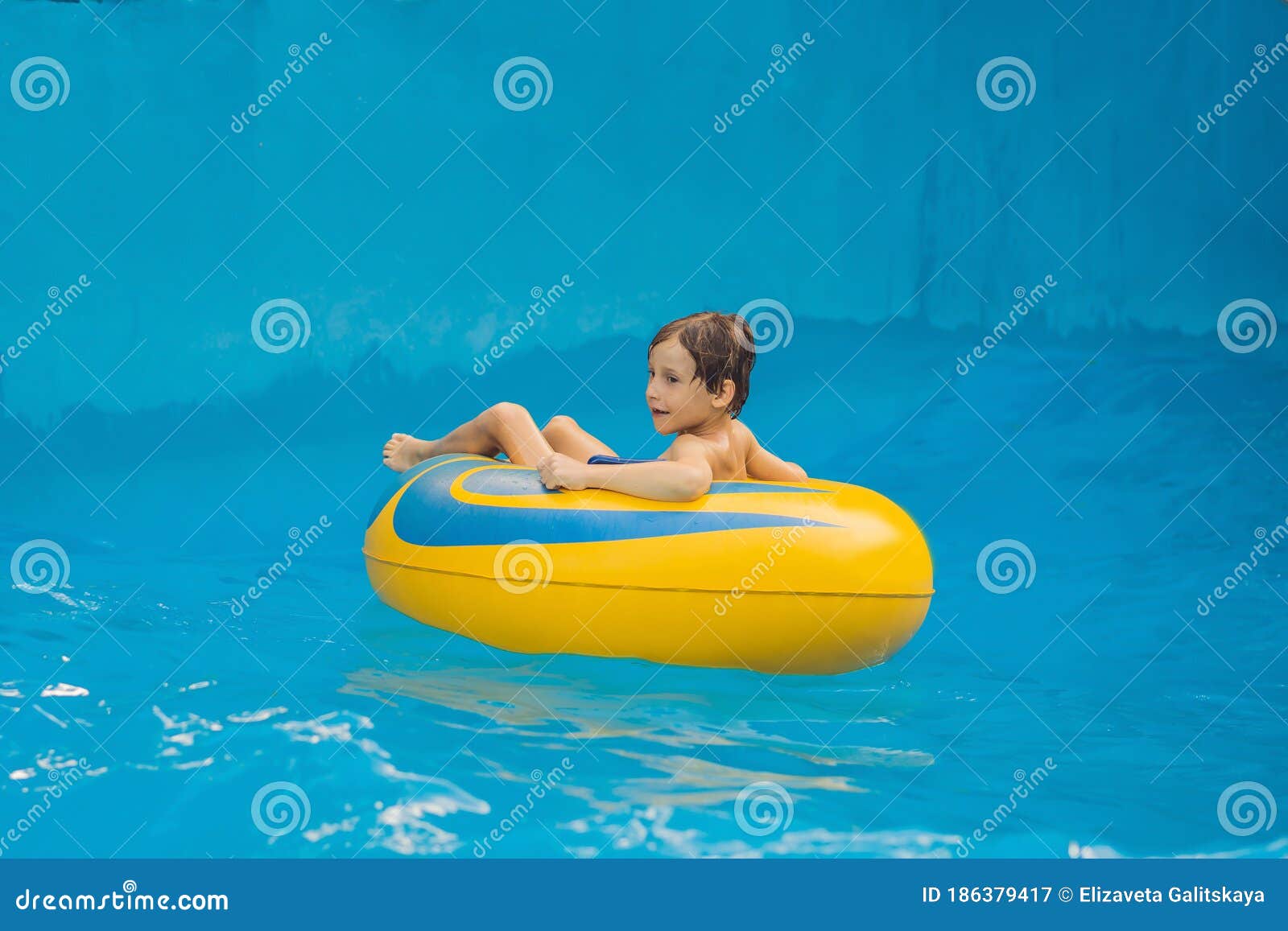 Boy on a Pool Float on Artificial Waves in a Water Park Stock Image ...