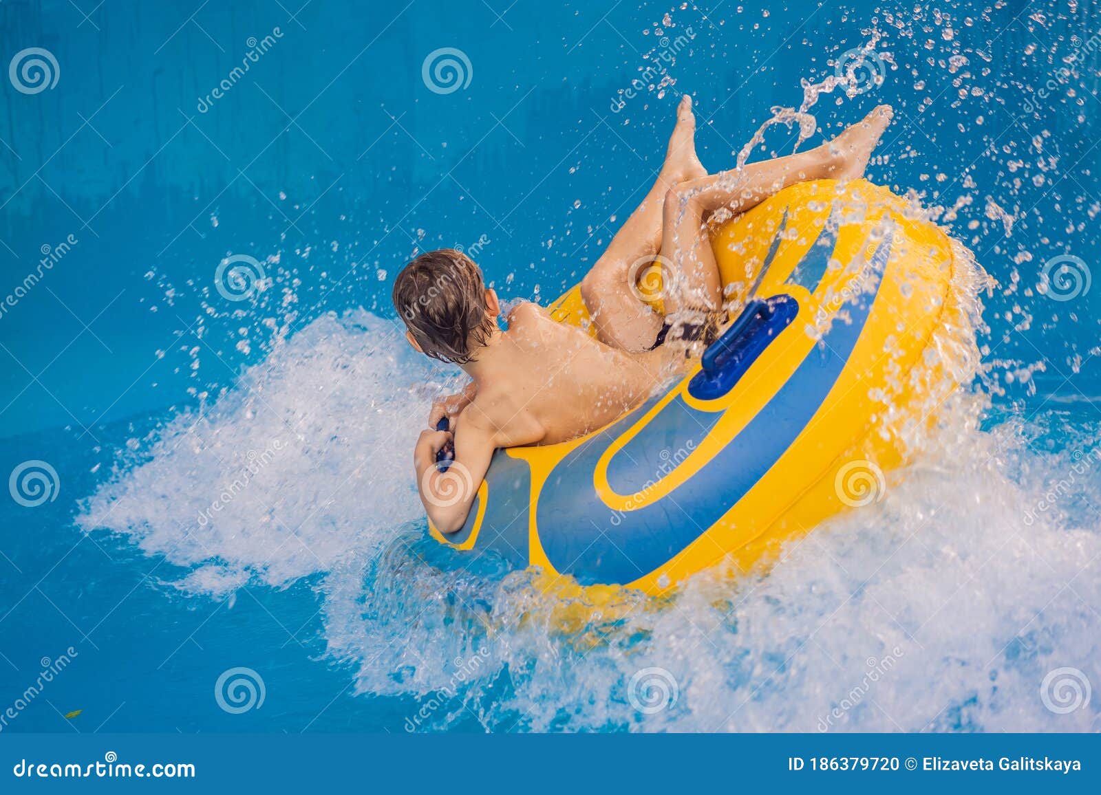 Boy on a Pool Float on Artificial Waves in a Water Park Stock Photo ...