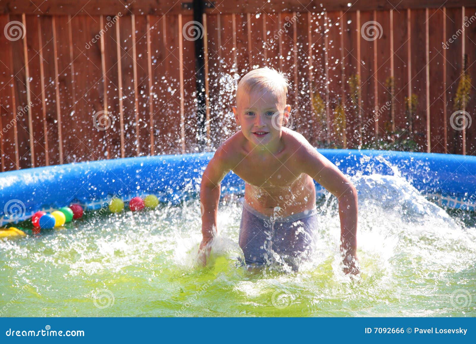 Boy in pool splashing stock photo. Image of preschooler - 7092666