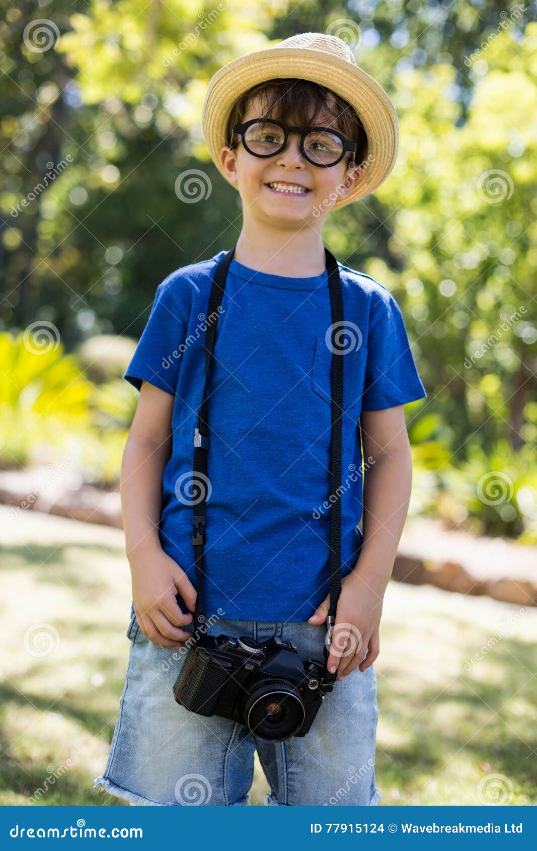 Boy Posing with a Camera Around His Neck Stock Photo - Image of grass ...