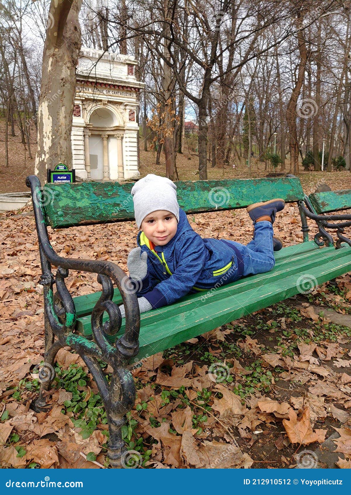 Boy posing on a parc bench stock photo. Image of picnic - 212910512