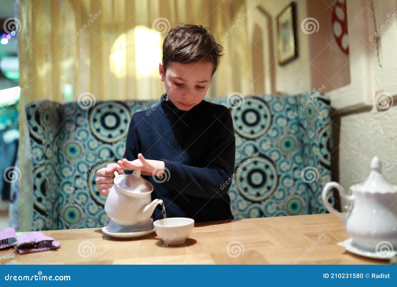 Boy Pouring Tea in Restaurant Stock Photo - Image of indoor, breakfast ...
