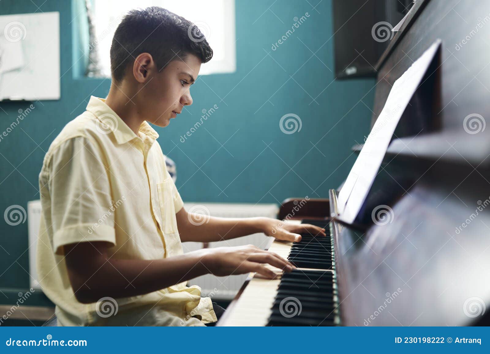 Boy Practicing Playing the Piano at Home Stock Photo - Image of ...