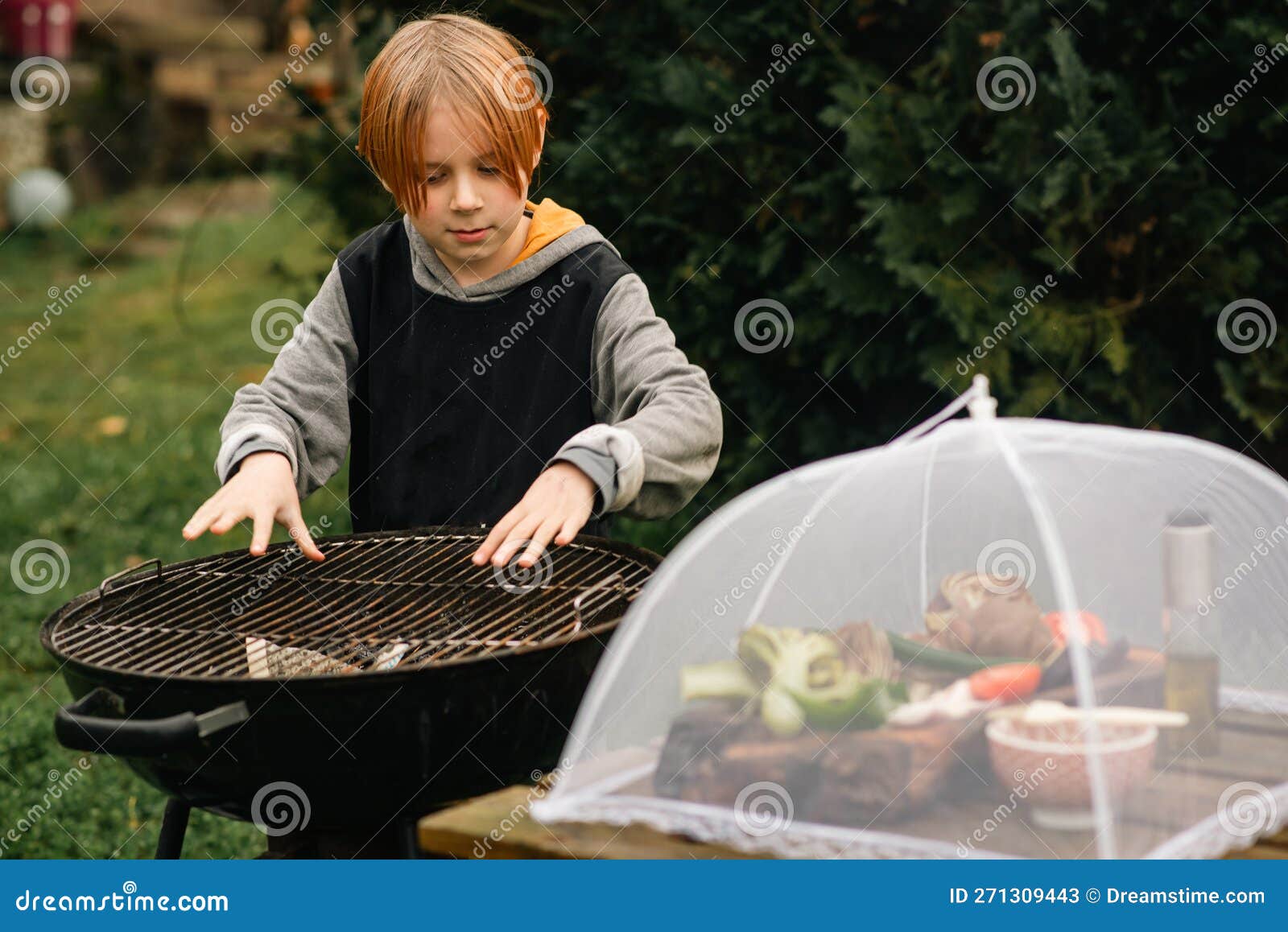 The Boy Prepares a Round Grill for Grilling Stock Image - Image of ...