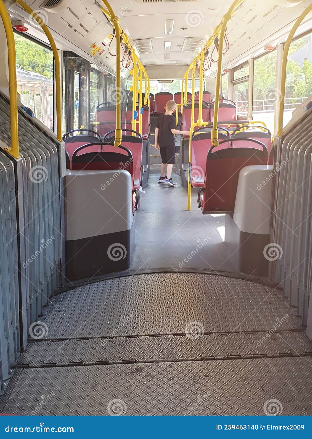 Boy in a Public Transport. Cute Boy Standing in Empty Schoolbus Stock ...