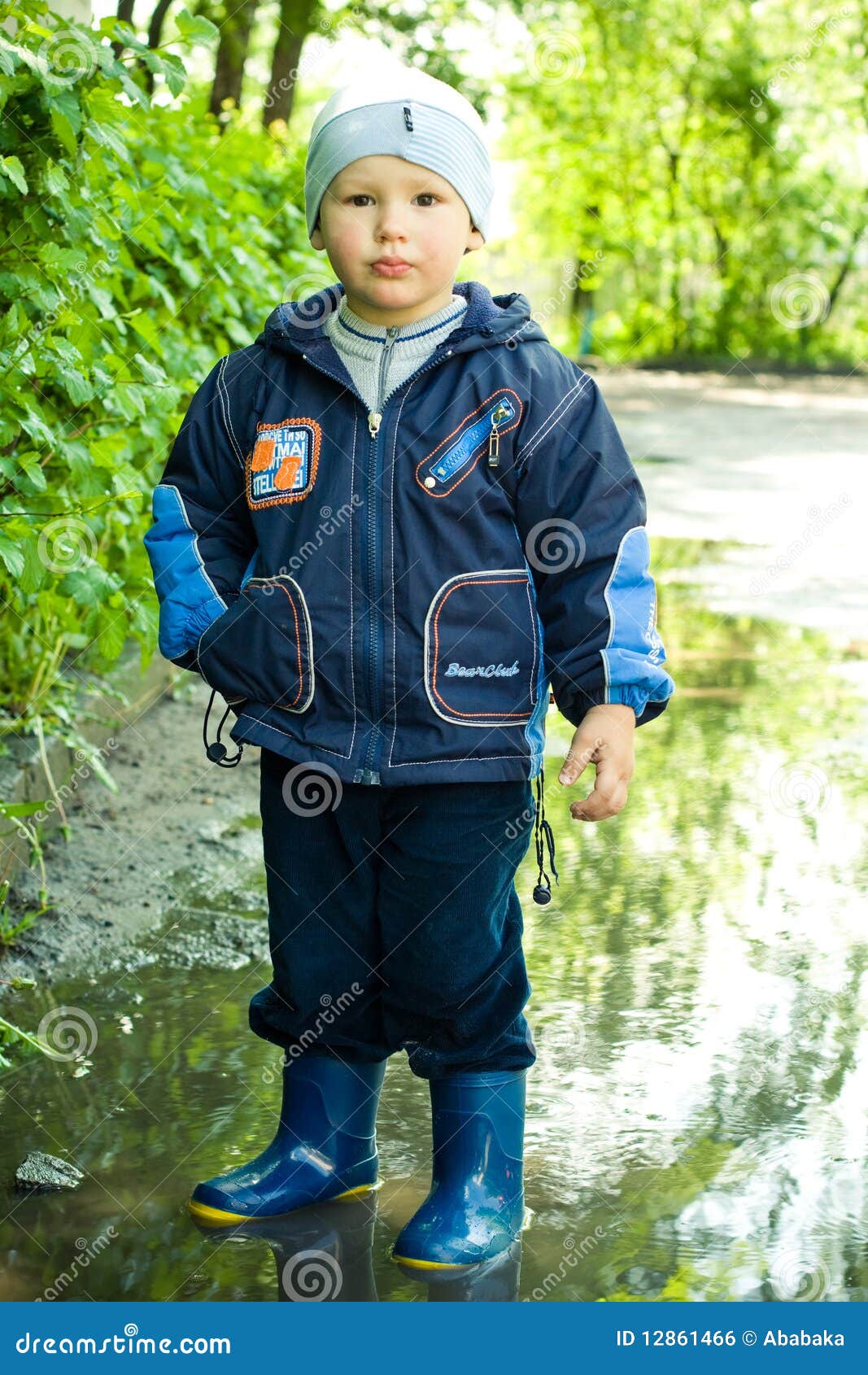 Boy in puddle stock photo. Image of play, rain, rainy - 12861466