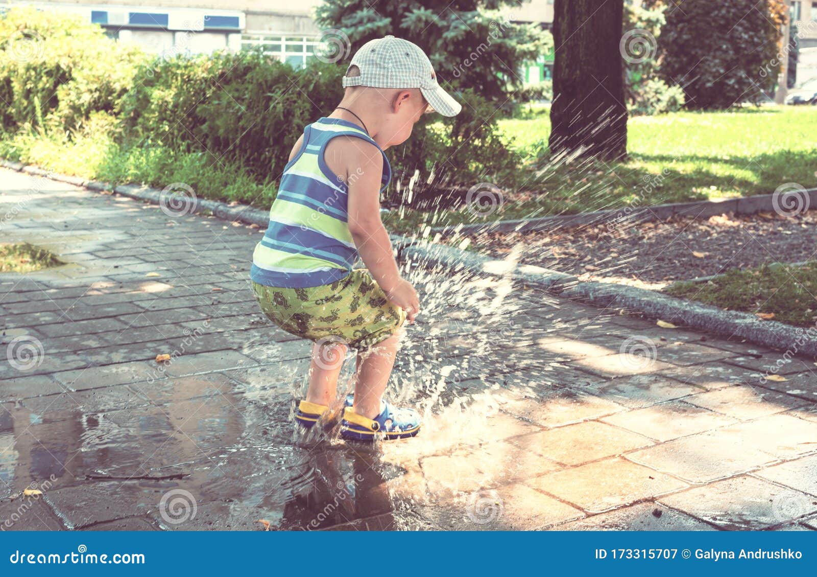 Boy in puddle stock image. Image of happy, asphalt, garden - 173315707