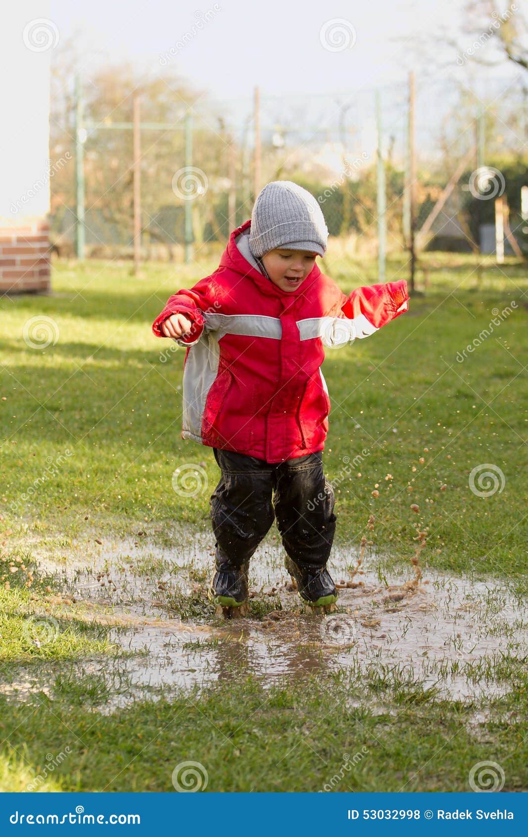 Boy in the puddle. stock photo. Image of splash, play - 53032998