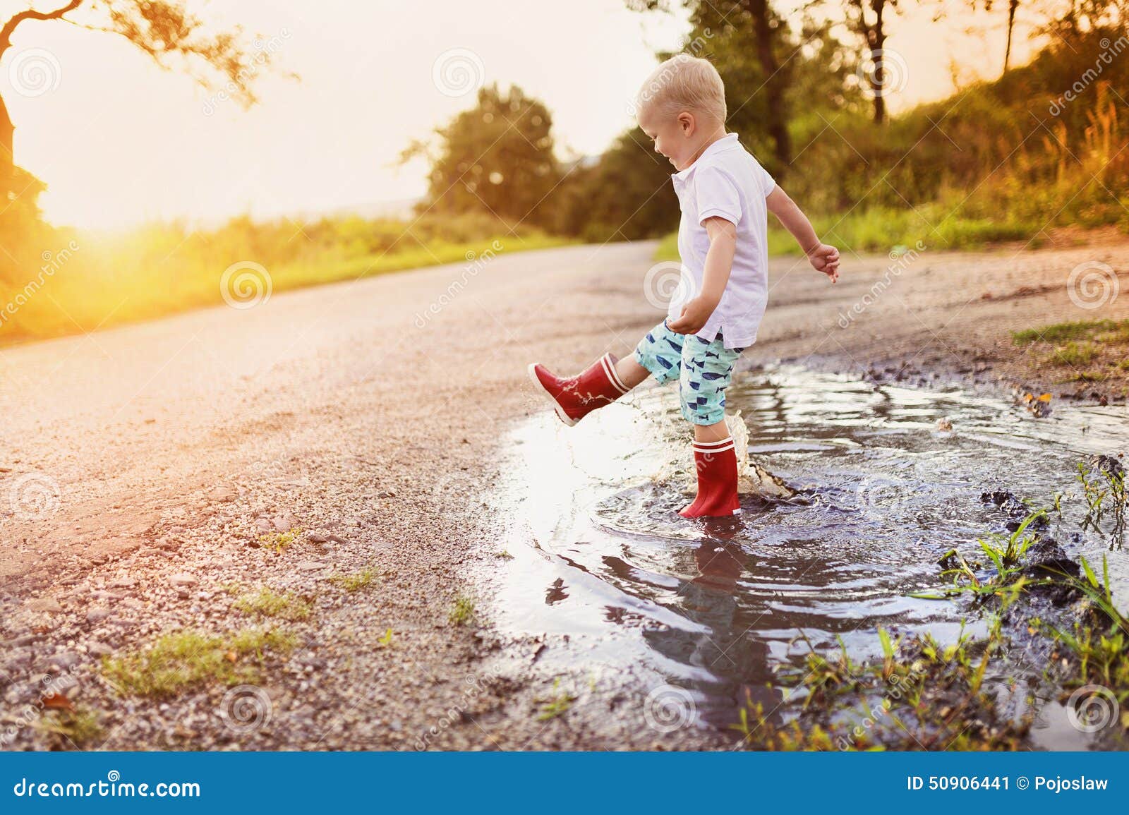 Boy in a puddle stock image. Image of green, shirt, healthy - 50906441