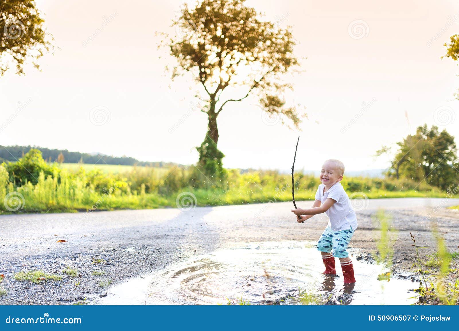 Boy in a puddle stock image. Image of shirt, park, enjoy - 50906507