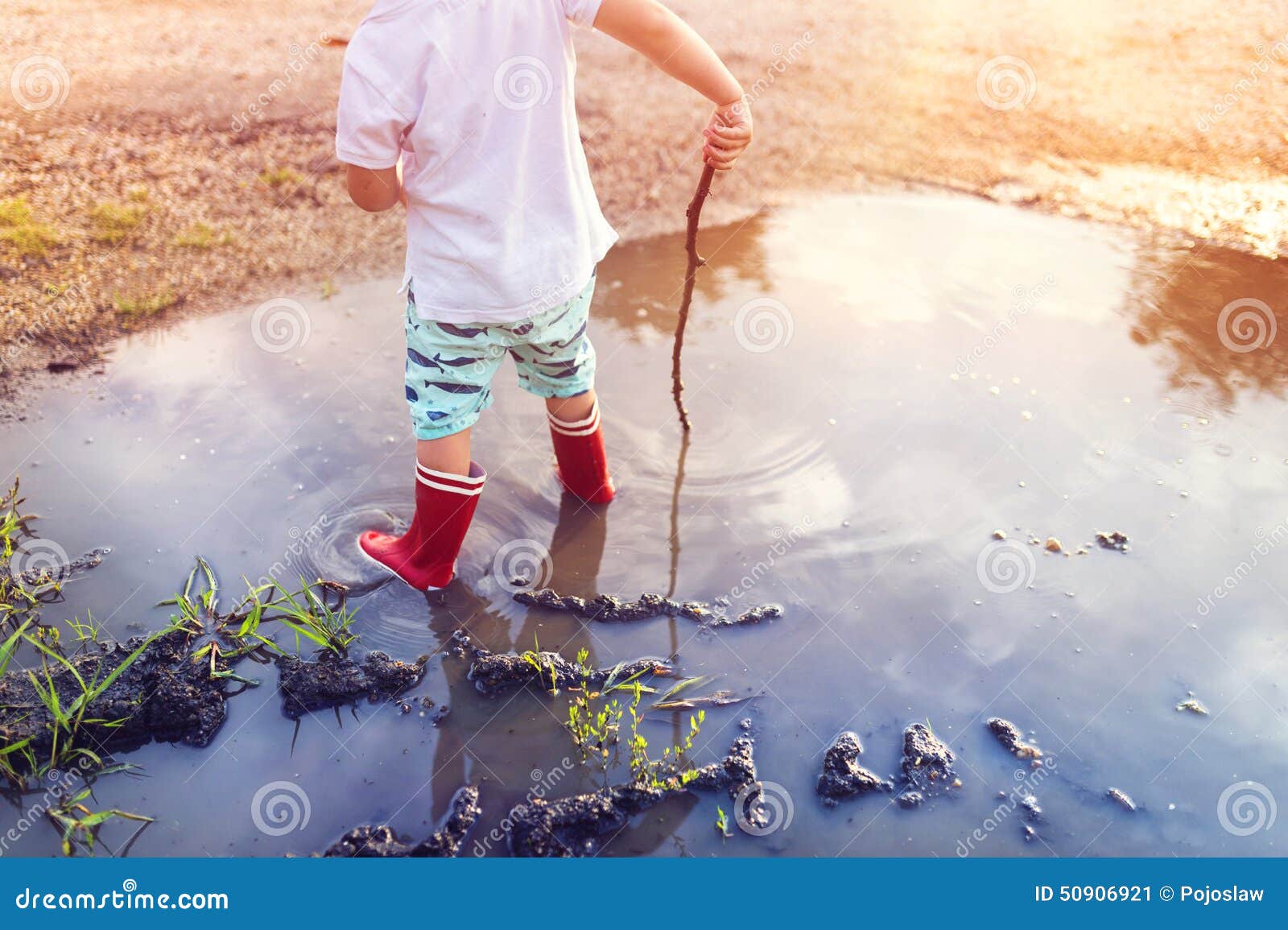 Boy in a puddle stock image. Image of childhood, shirt - 50906921