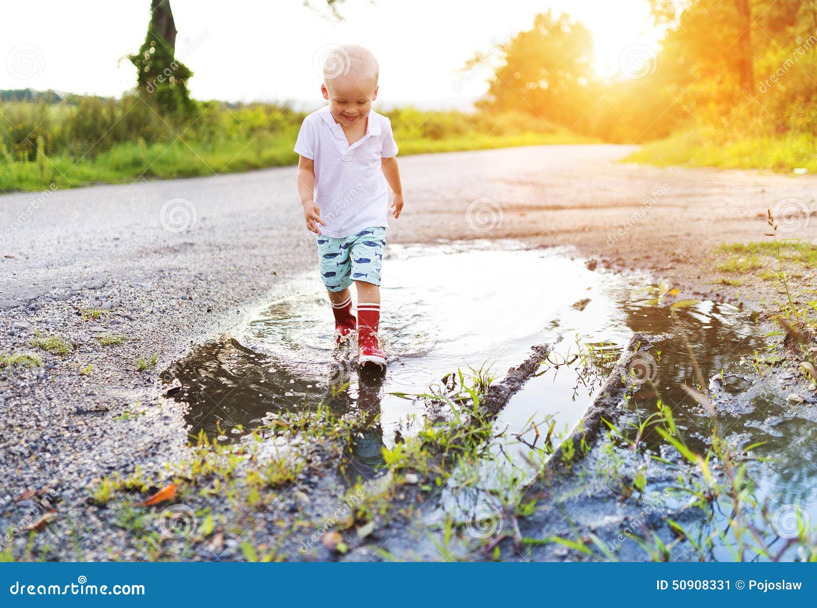Boy in a puddle stock image. Image of nature, active - 50908331