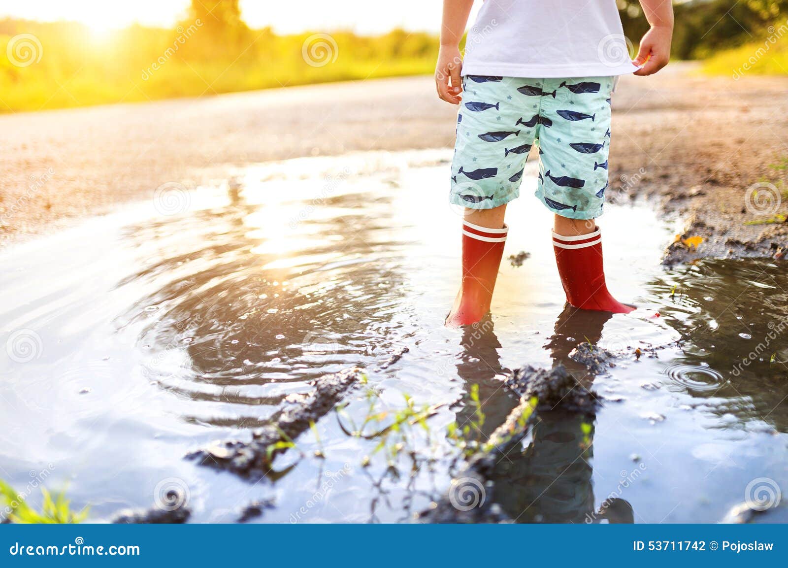 Boy in a puddle stock photo. Image of spring, shirt, childhood - 53711742