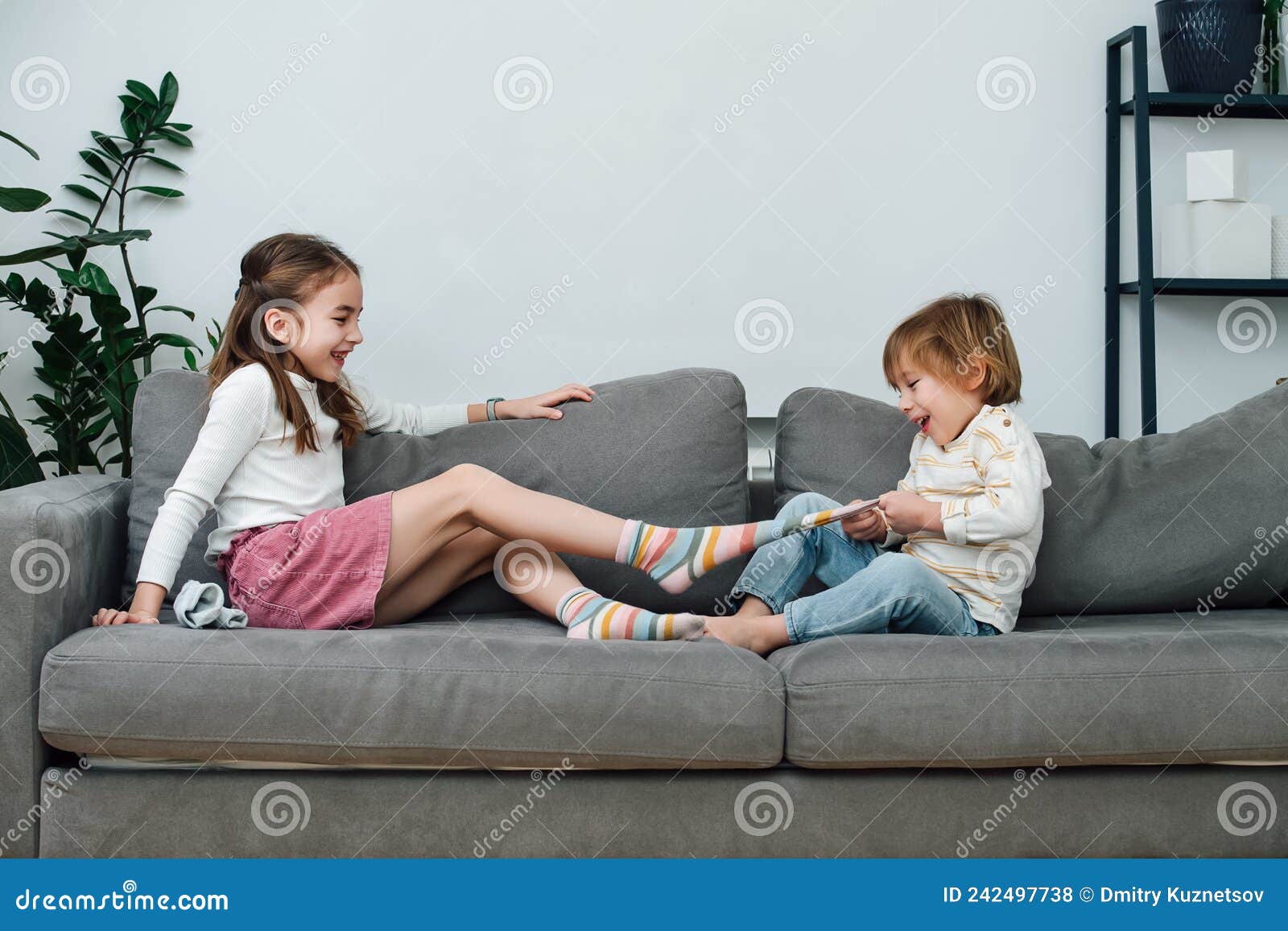 Boy Pulling Off Sock of a Girl, they are Preparing for a Tickling ...
