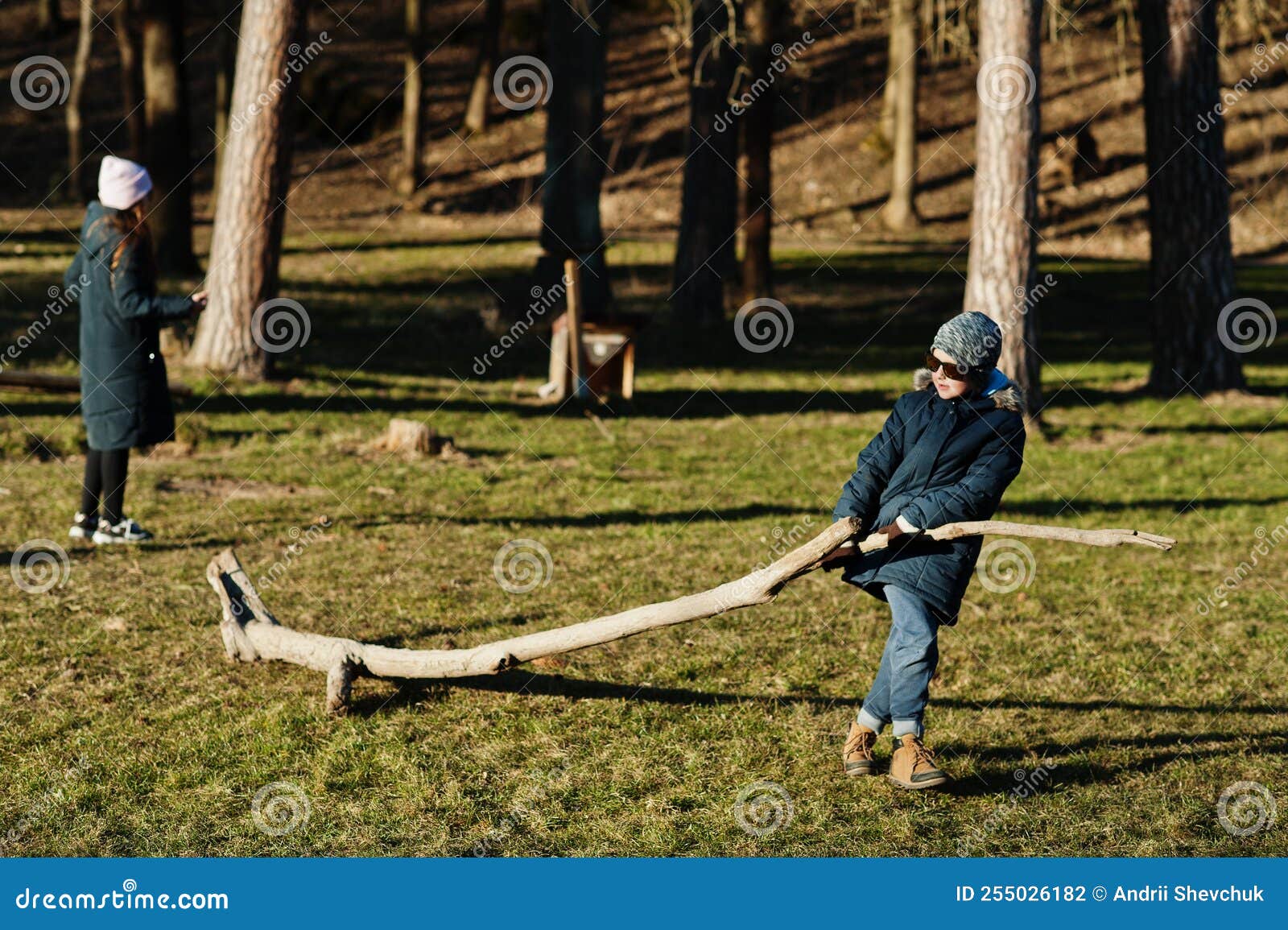 Boy Pulls a Tree in Spring Sunny Park Stock Photo - Image of male, wide ...