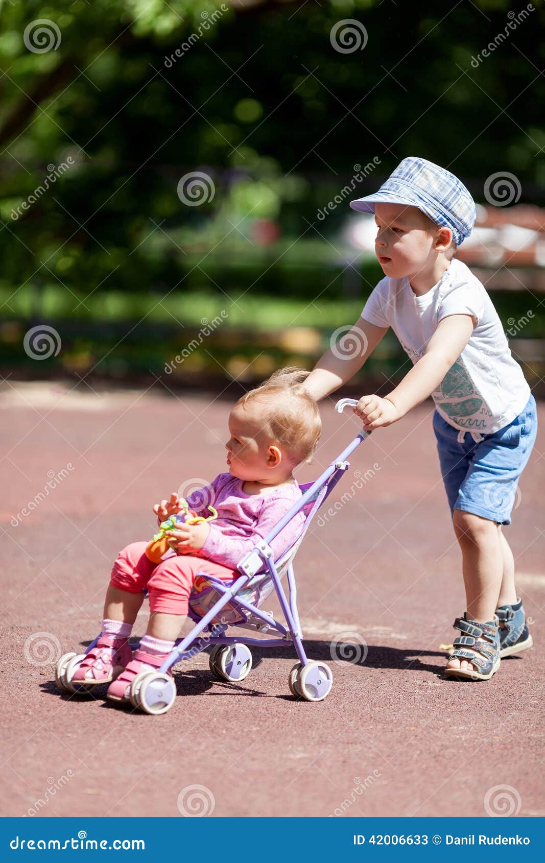 Boy Pushing Sister in a Stroller Stock Image - Image of child, girl ...