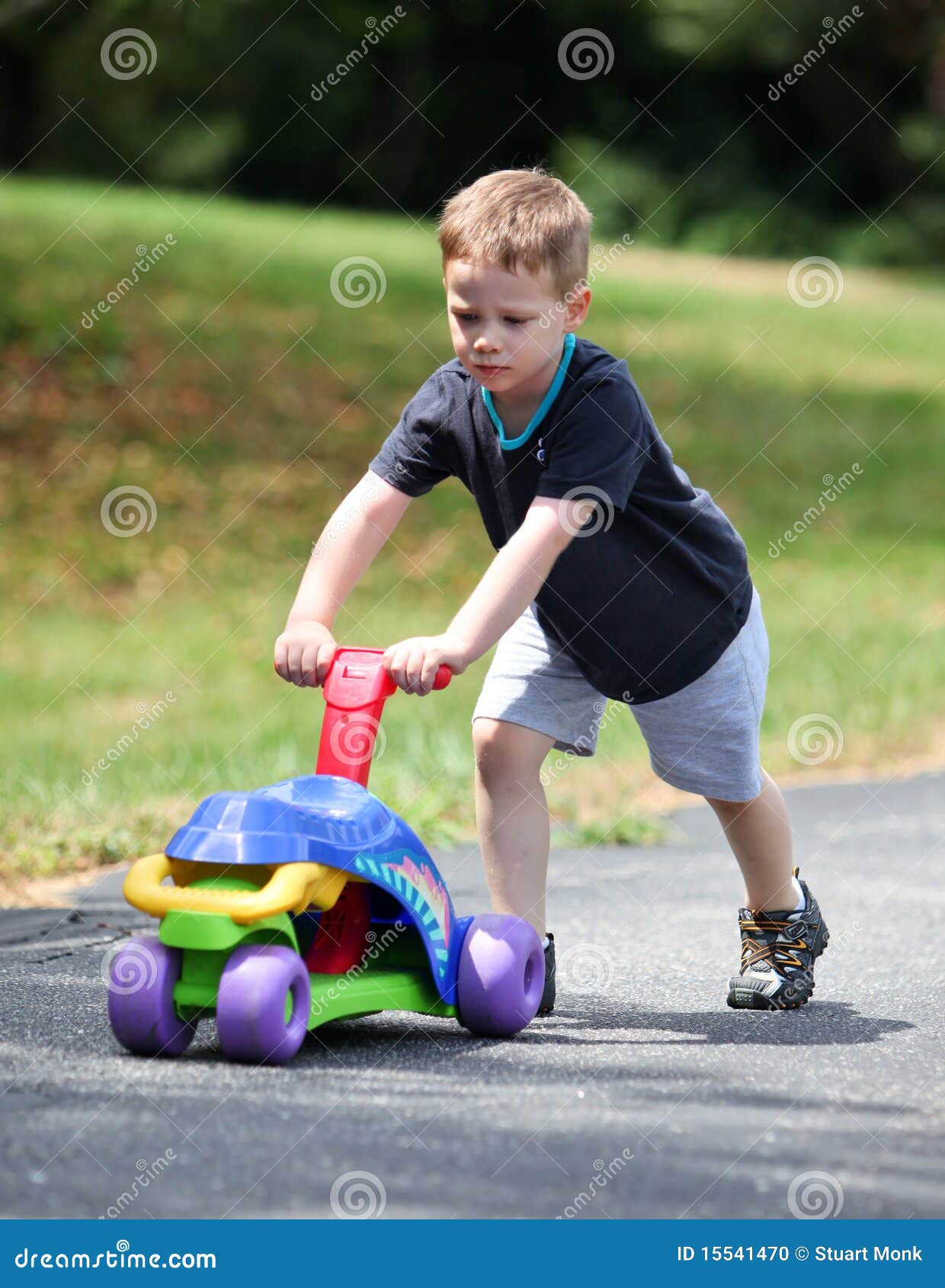 Boy pushing toy bike stock photo. Image of pushing, working - 15541470