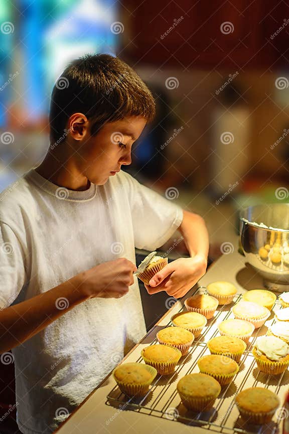 Boy Putting Icing on Cupcakes. Stock Image - Image of face, cakes: 61820323