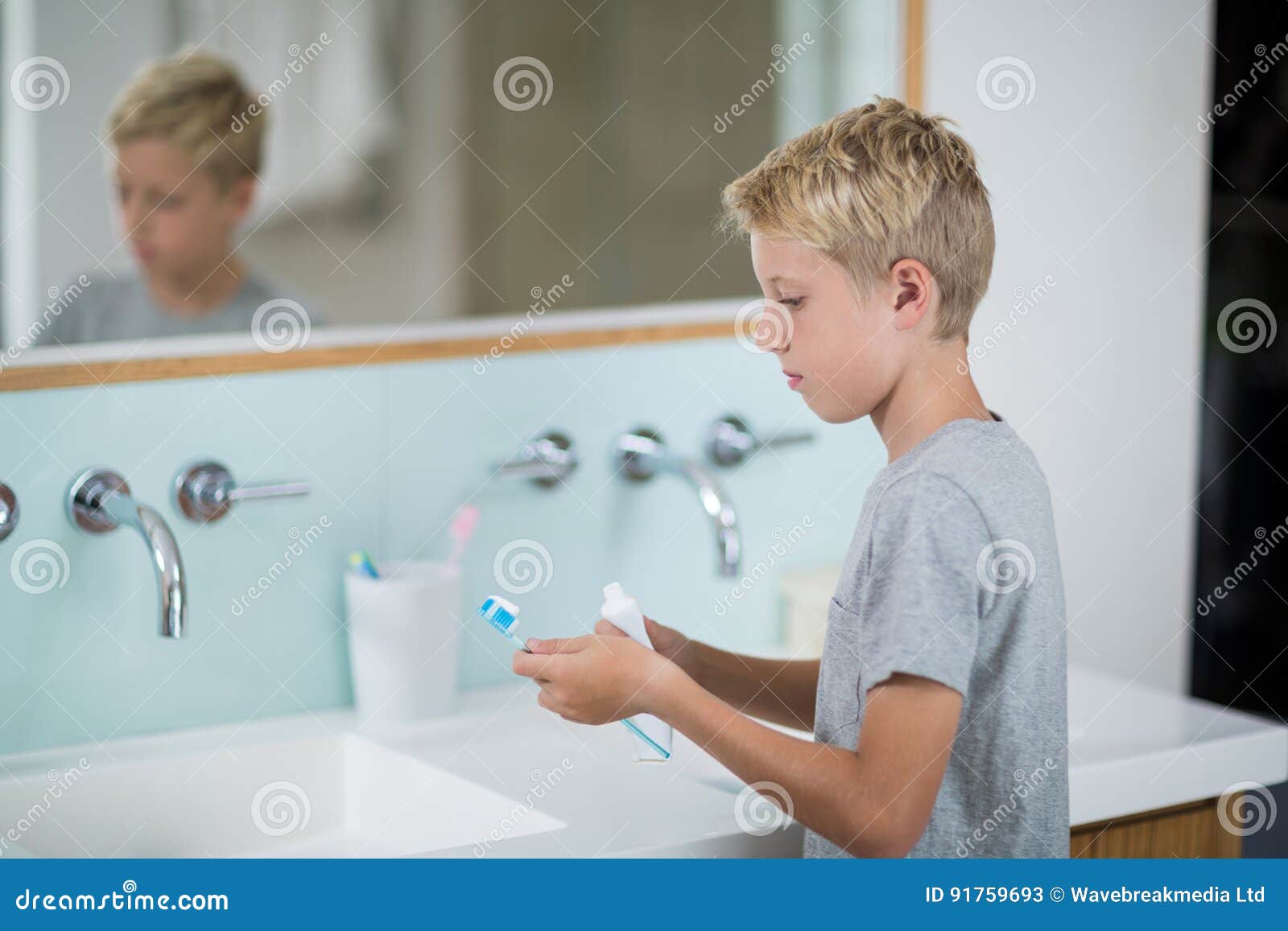Boy Putting Toothpaste on Brush in Bathroom Stock Image - Image of ...