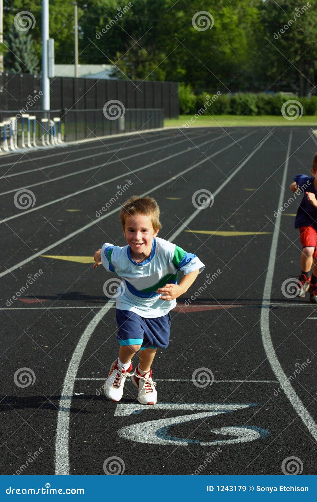 Boy Racing on Track stock image. Image of laughing, close - 1243179