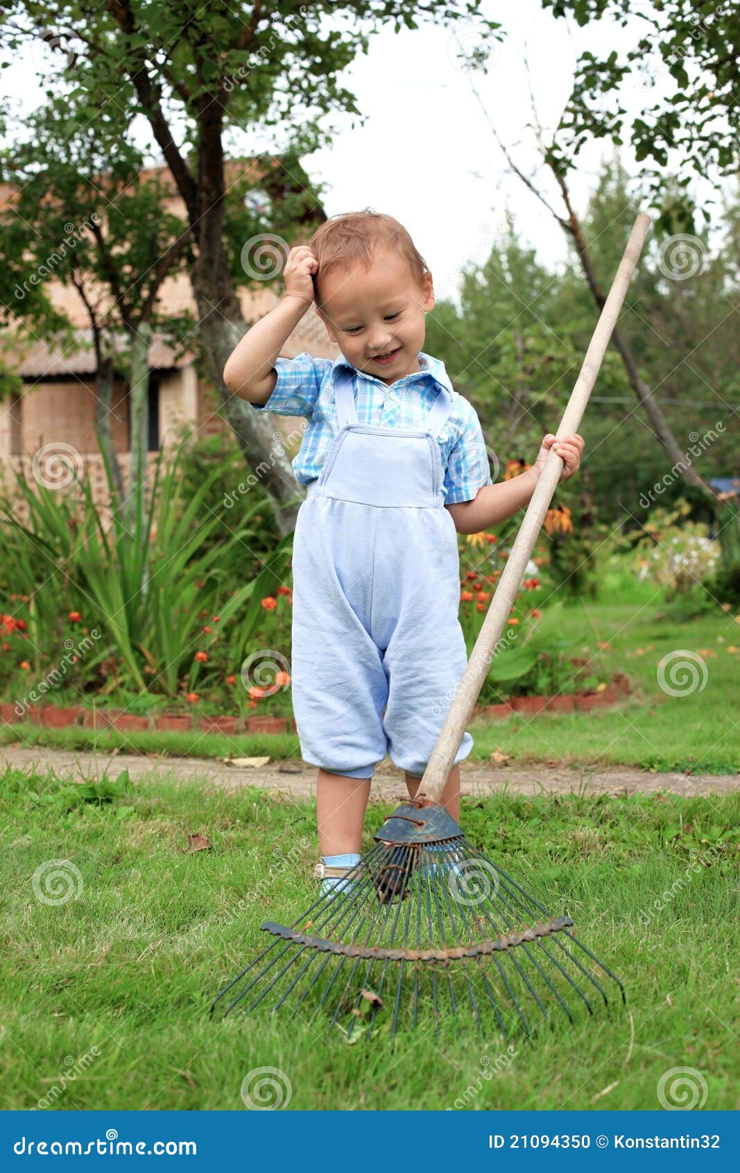 Boy raking in the garden stock photo. Image of tree, pile - 21094350