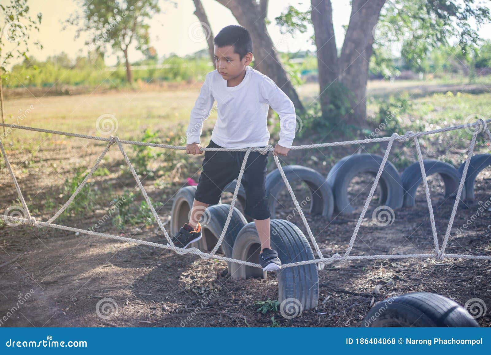 The Boy Ran with a Rope Hanging in an Amusement Park Stock Photo ...
