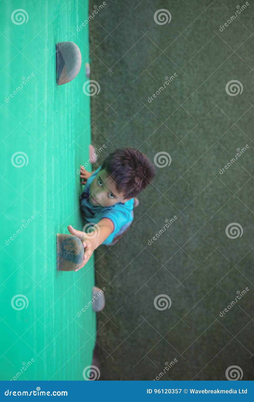 Boy Reaching Climbing Holds On Green Wall Royalty-Free Stock Photo ...