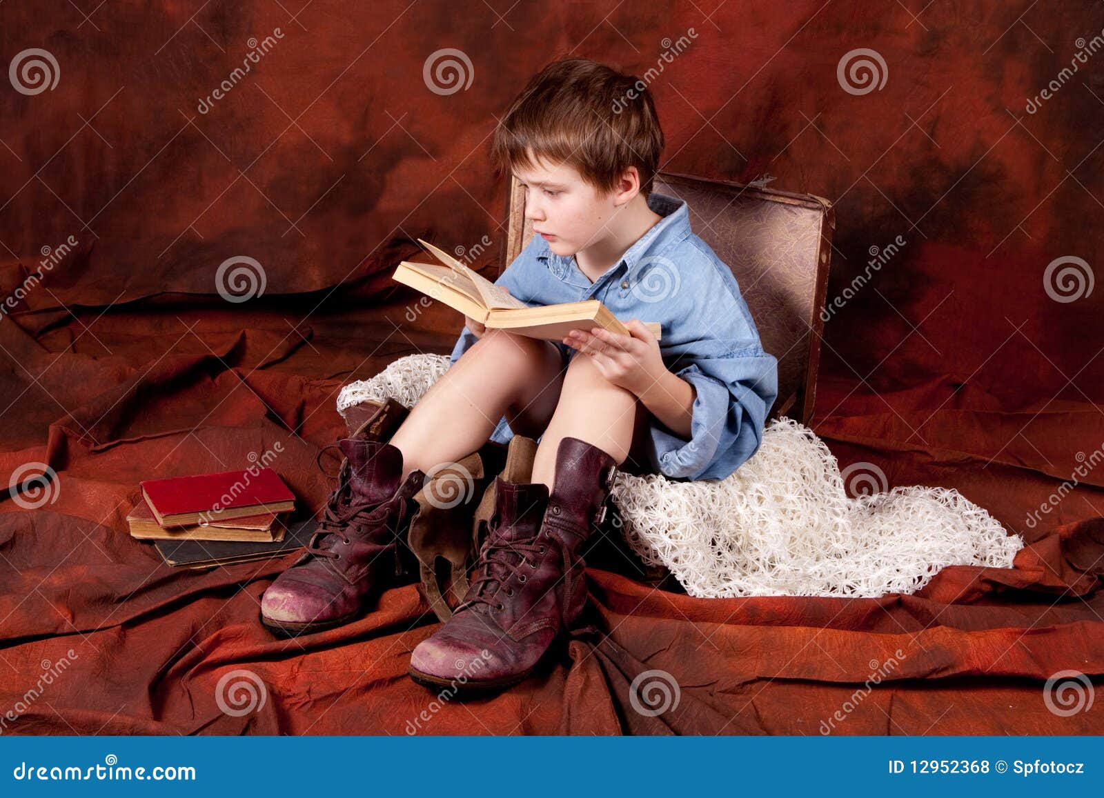 A boy reading a book stock photo. Image of book, blue - 12952368