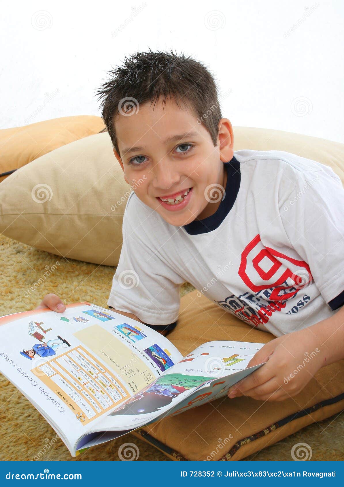 Boy Reading a Book on the Floor Stock Photo - Image of amused ...