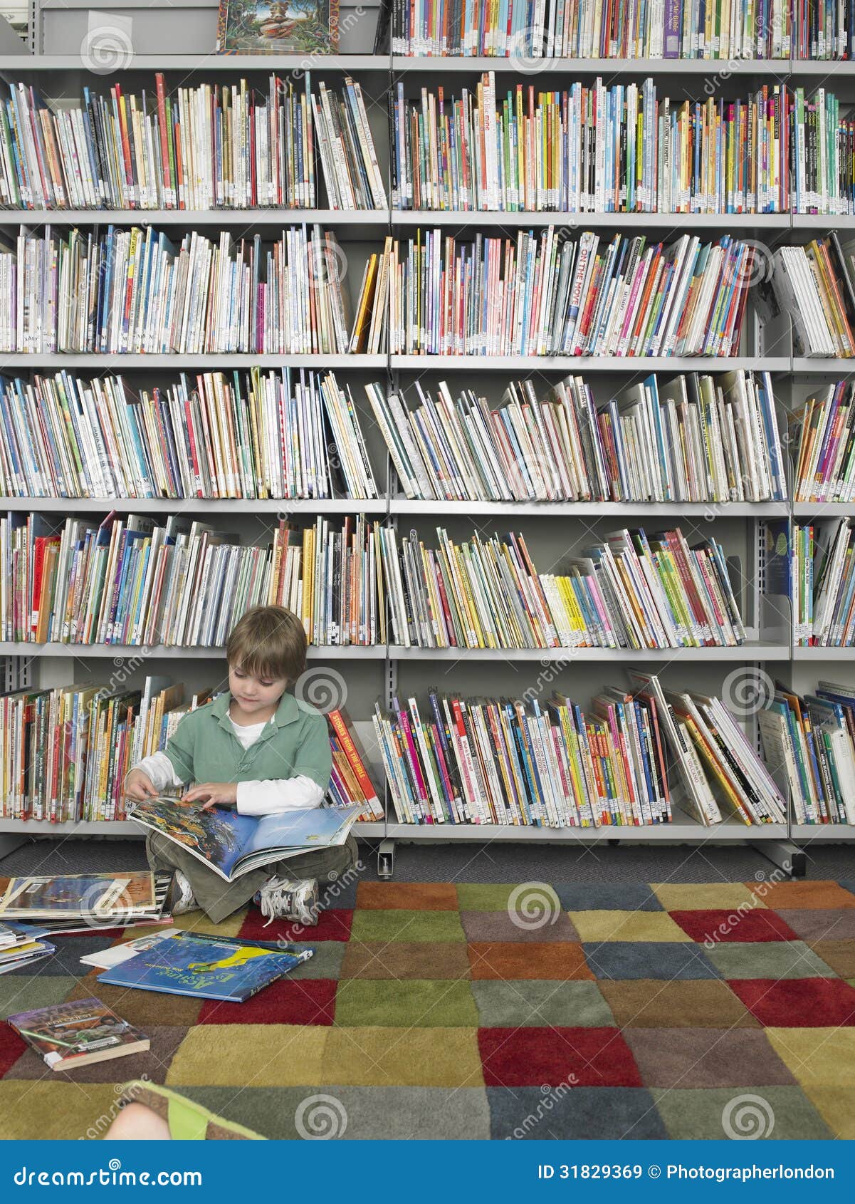 Boy Reading Book in Library Stock Image - Image of innocence, children ...