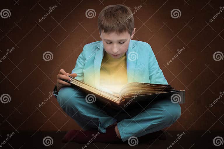 The boy is reading a book stock photo. Image of imagination - 281836902