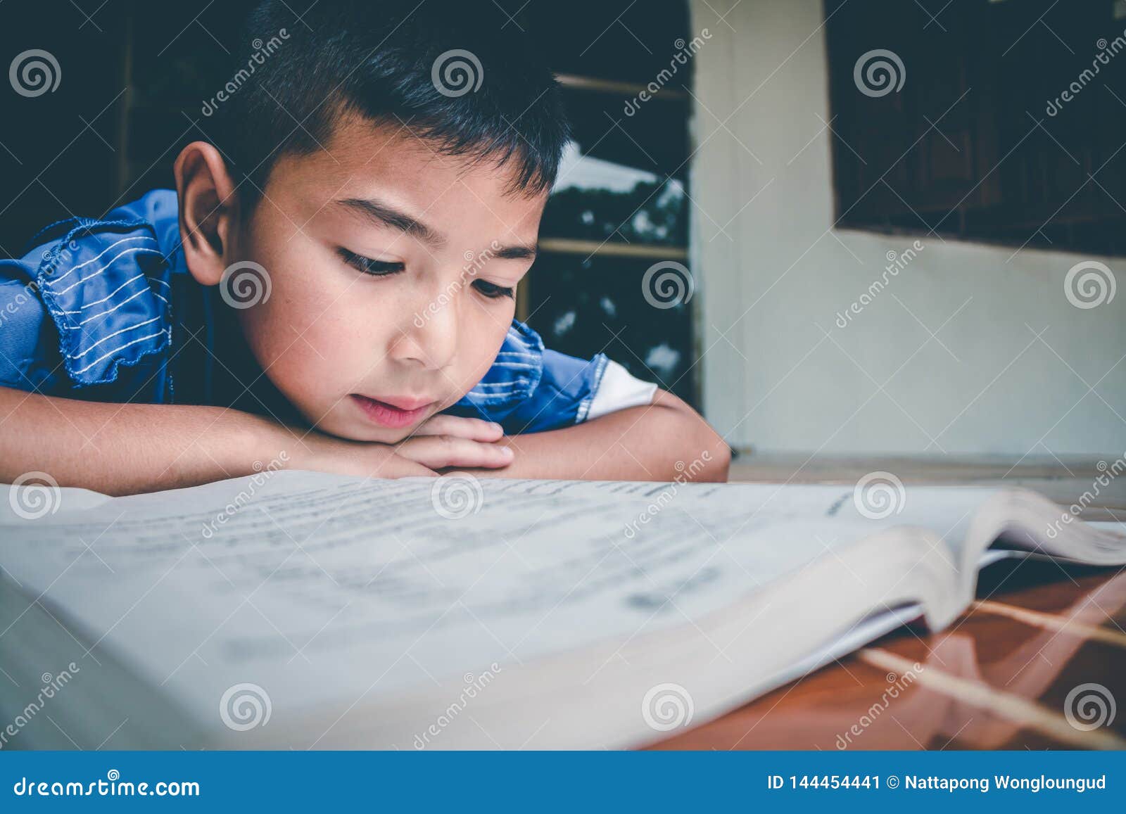 The Boy is Reading the Book for Prepare the Exam on this Coming Monday ...