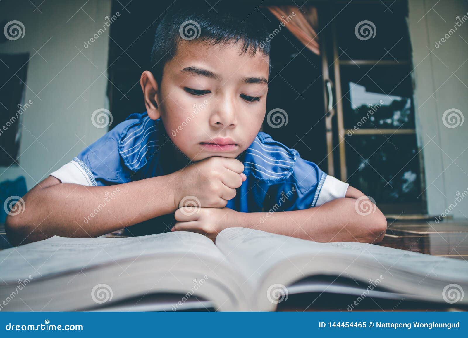 The Boy is Reading the Book for Prepare the Exam on this Coming Monday ...