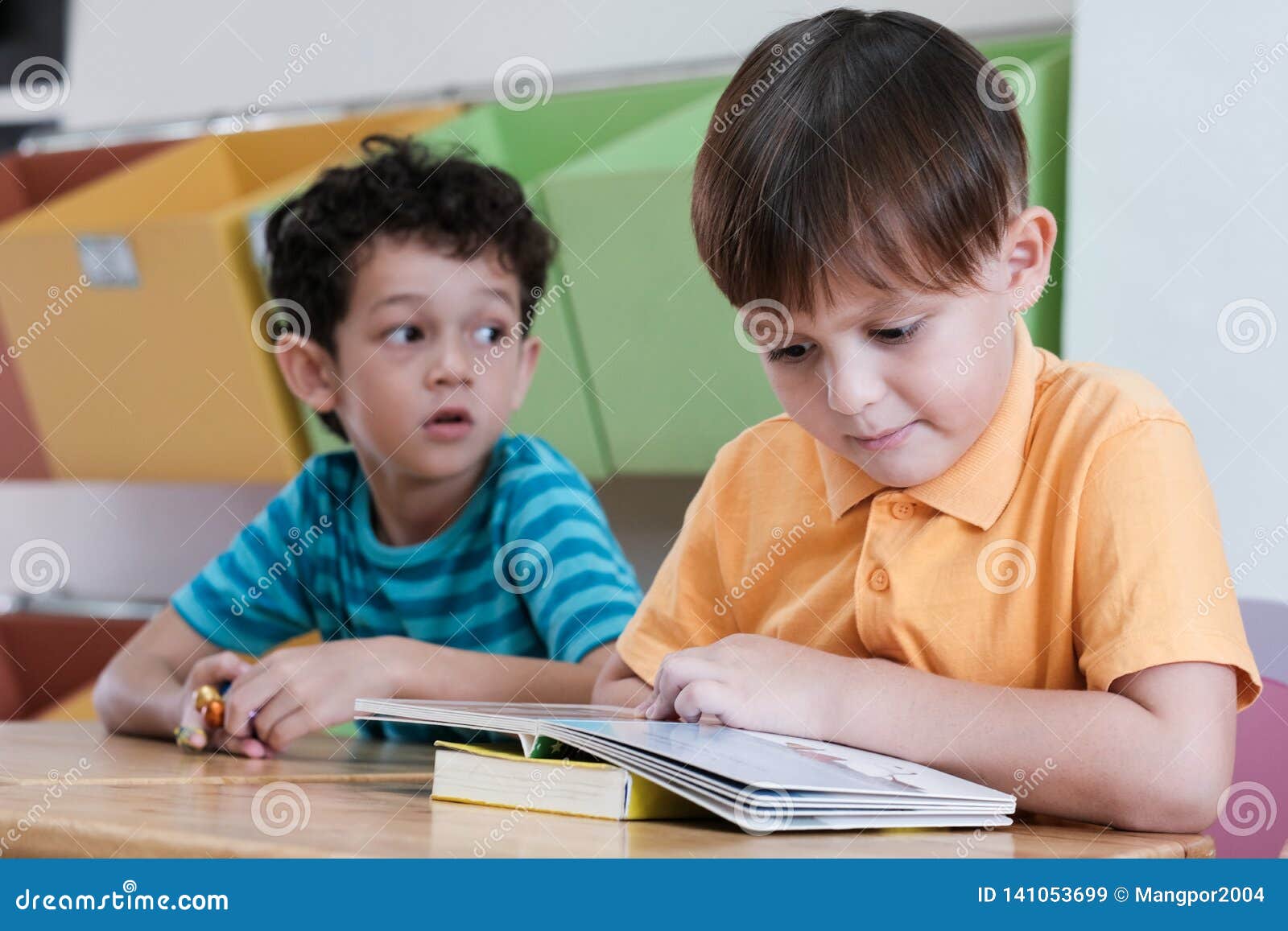 Boy Reading Book in Their Kindergarten Classroom, Kid Education Concept ...