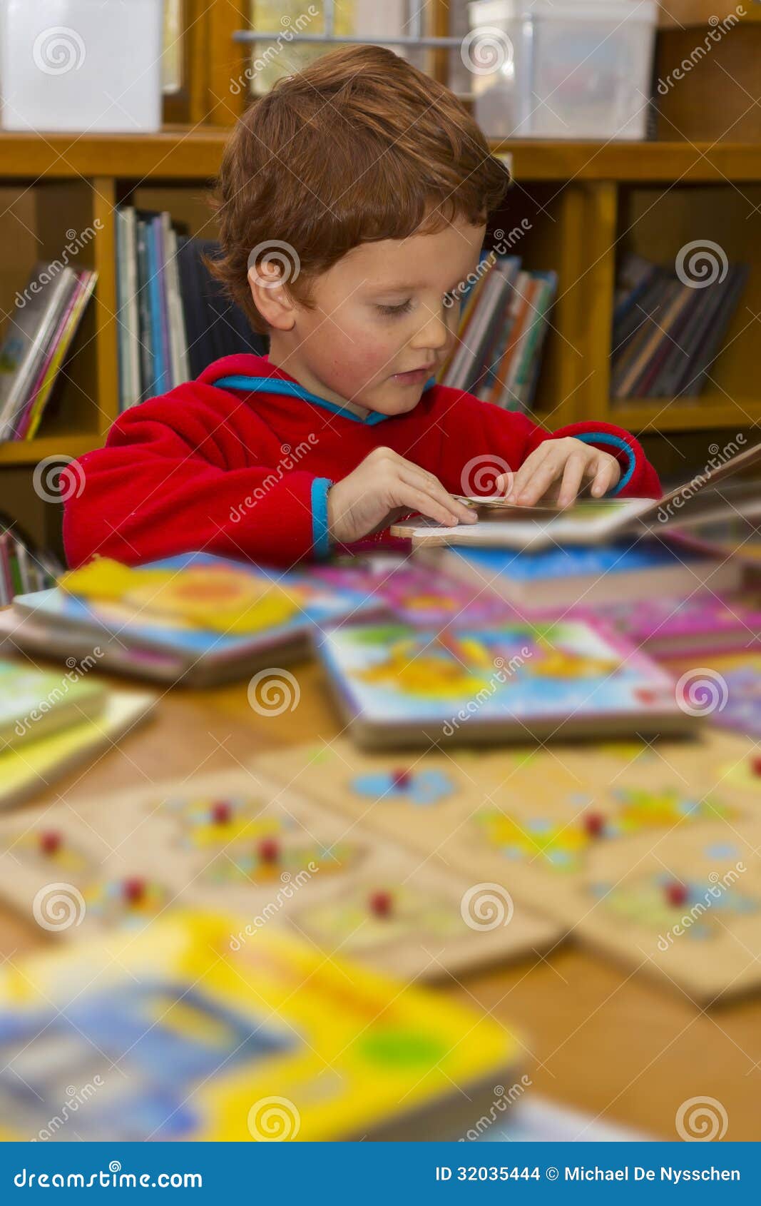 Boy Reading Books in a Library Stock Photo - Image of look, sitting ...