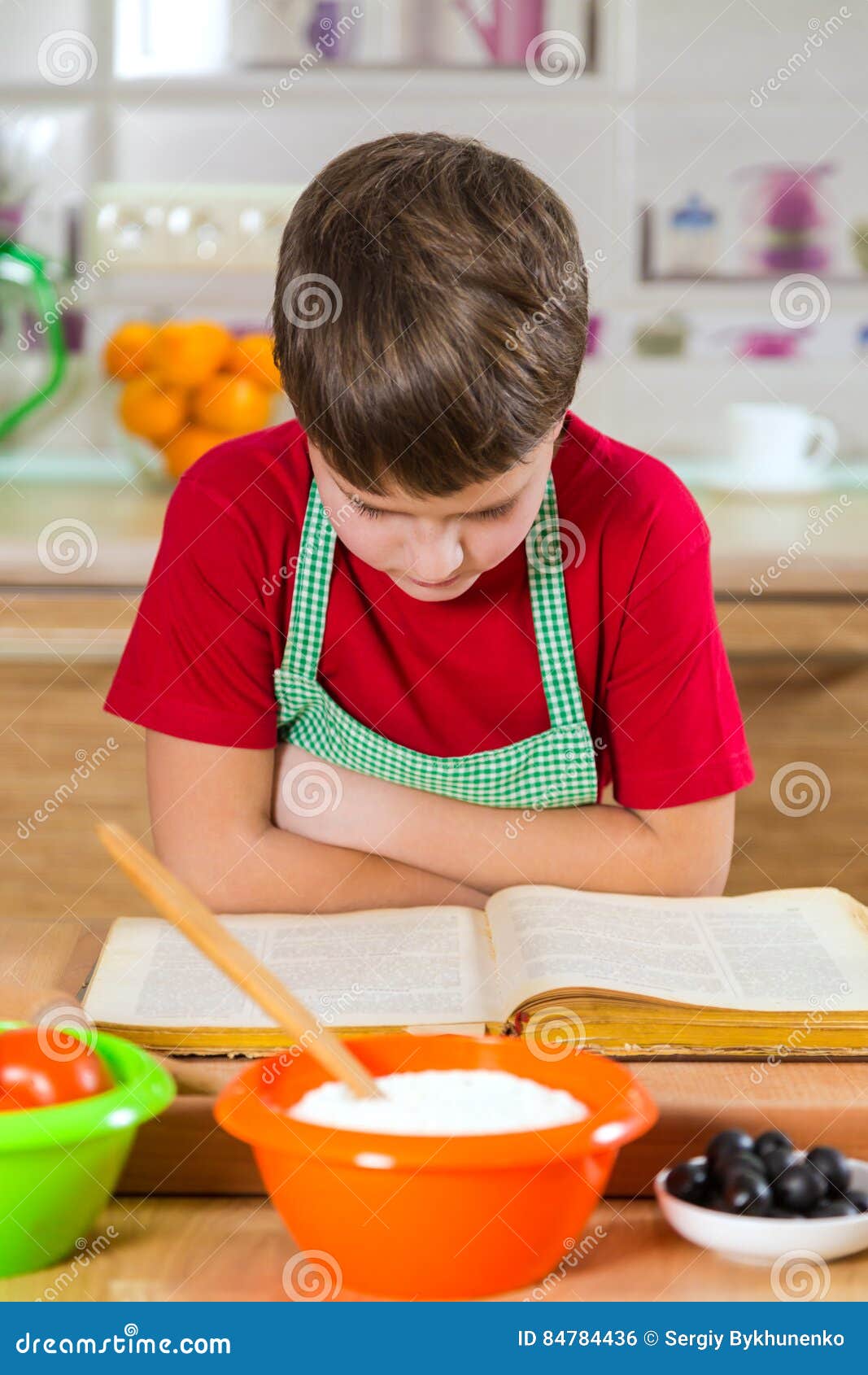 Boy Reading the Cook Book for Making the Dinner Stock Photo - Image of ...