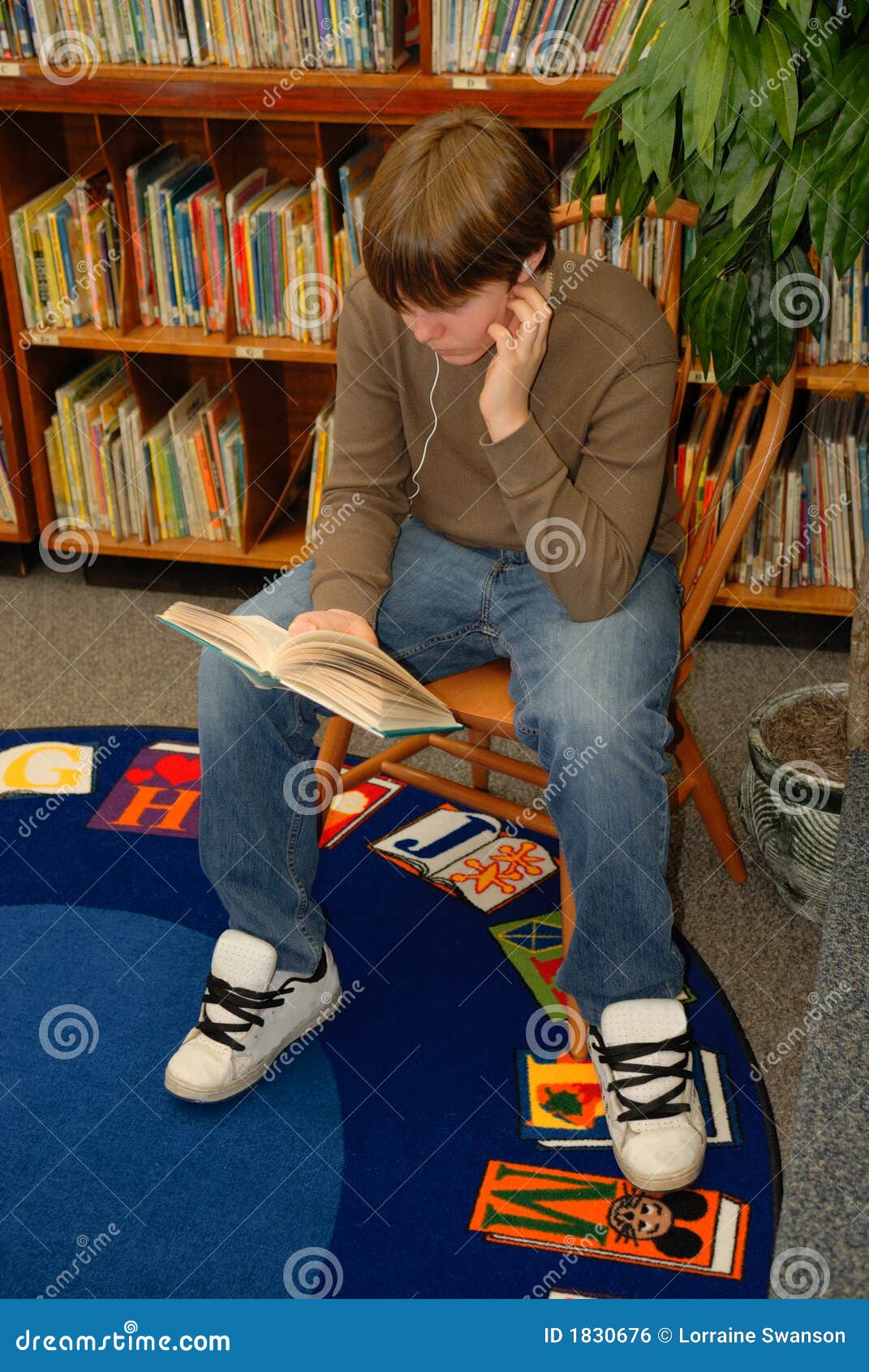 Boy Reading in Library stock photo. Image of student, library - 1830676